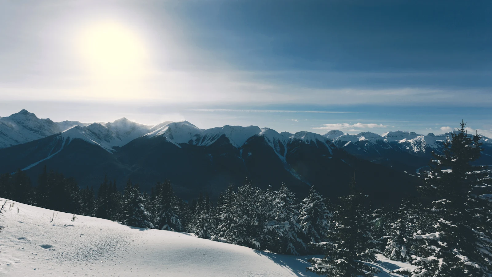 Snowy Mountain Vista Under Bright Sun 4K Desktop Wallpaper