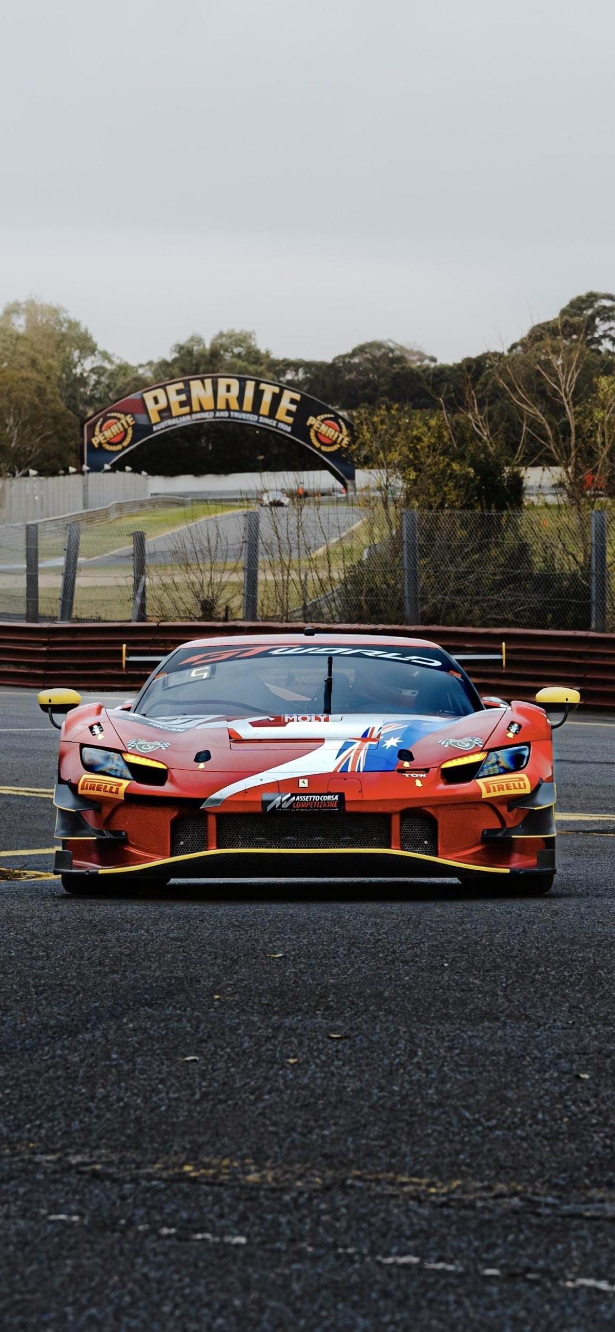 Red Race Car On Paddock Road Full HD iPhone Wallpaper